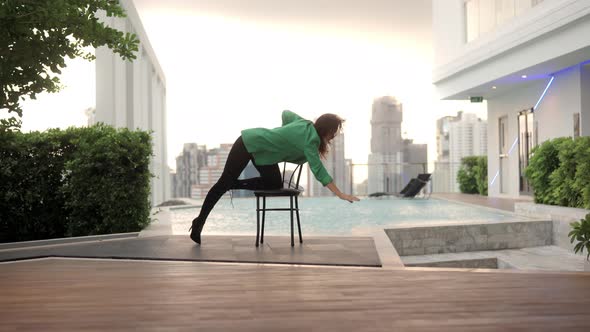 Dancer Moving Around Chair On Poolside, Stock Footage | VideoHive