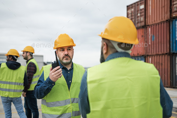 Industrial engineers working in logistic terminal of container cargo ...