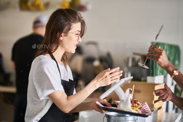 waitress handing order of food on tray to customer Stock Photo by ...