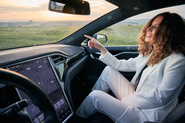 Female passenger in car pointing to road ahead. Stock Photo by anatoliy ...
