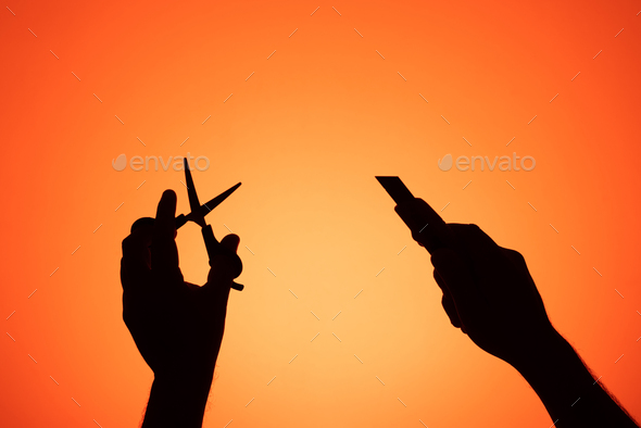 Hands holding homemade cutting tools. Photography with silhouettes ...