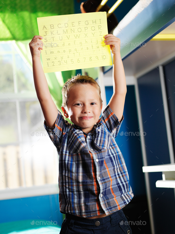 cute little boy showing his alphabet worksheet Stock Photo by joshua ...