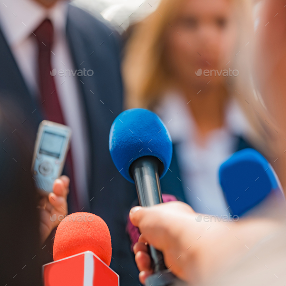 Media interview, a politician talking to reporters Stock Photo by microgen