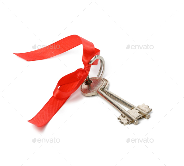 Two metal house door keys with red ribbon isolated on white background ...