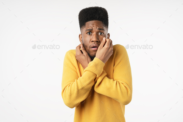 Portrait of scared man. Young man standing isolated on white studio ...