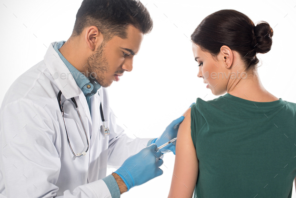 Handsome doctor doing vaccine injection to patient isolated on white ...