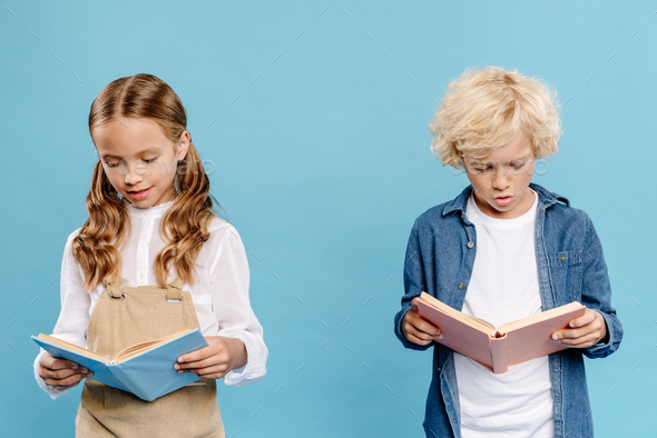 smiling and shocked kids reading books isolated on blue Stock Photo by ...