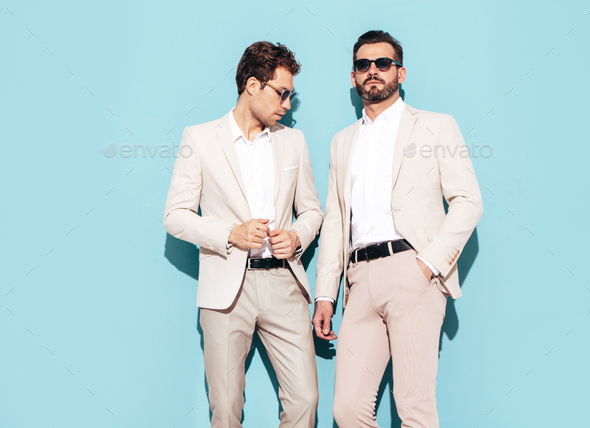 Two handsome men in suit posing in studio Stock Photo by halayalex