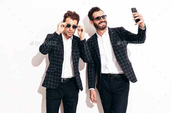 Two handsome men in suit posing in studio Stock Photo by halayalex
