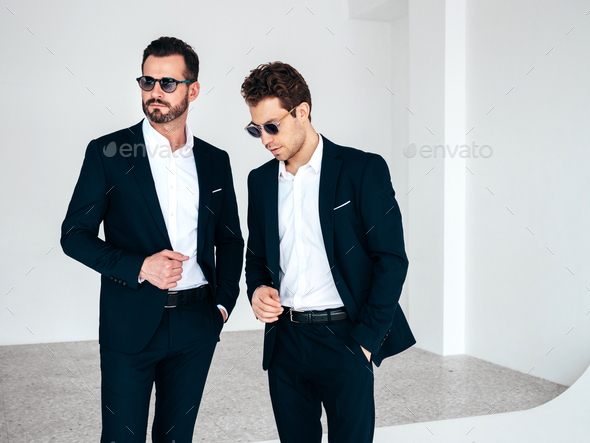 Two handsome men in suit posing in studio Stock Photo by halayalex
