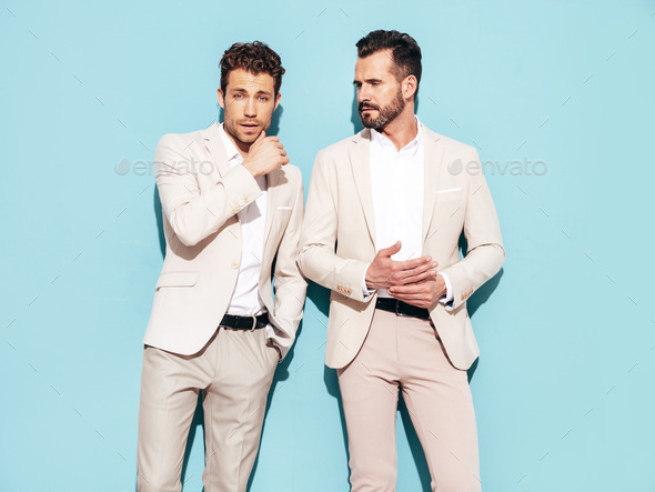 Two handsome men in suit posing in studio Stock Photo by halayalex