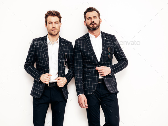 Two handsome men in suit posing in studio Stock Photo by halayalex