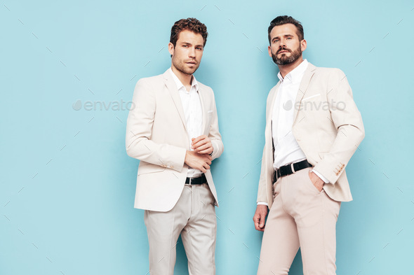Two handsome men in suit posing in studio Stock Photo by halayalex