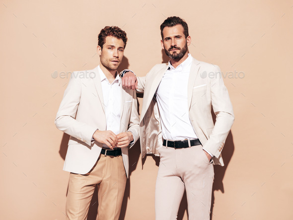 Two handsome men in suit posing in studio Stock Photo by halayalex
