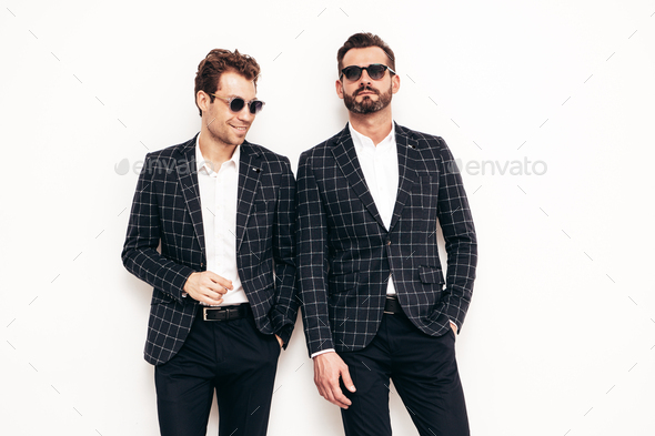Two handsome men in suit posing in studio Stock Photo by halayalex