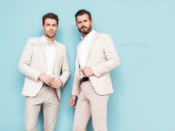 Two handsome men in suit posing in studio Stock Photo by halayalex