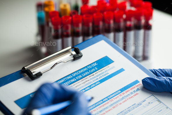 Lab technician filling out specimen submitting form Stock Photo by drecun