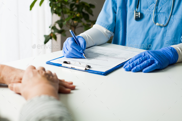 General Practitioner completing patient examination in doctor's office ...