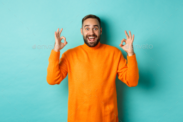 Impressed man praising something awesome, showing okay signs and ...