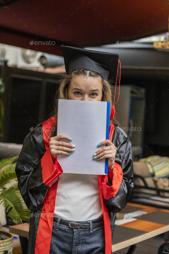 Vertical portrait of beautiful student wearing a graduation cape Stock ...