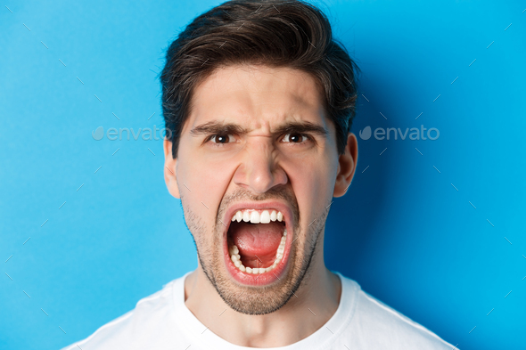 Head shot of angry man shouting and looking with hatred, standing mad ...