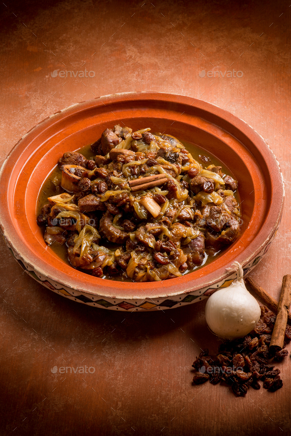 open tajine with meat, onion, dried grape and cinnamon Stock Photo by ...