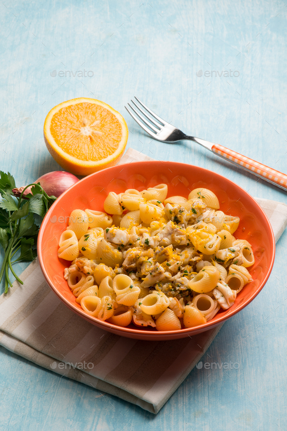 pasta with fish ragout and grated orange peel Stock Photo by MarcoMayer