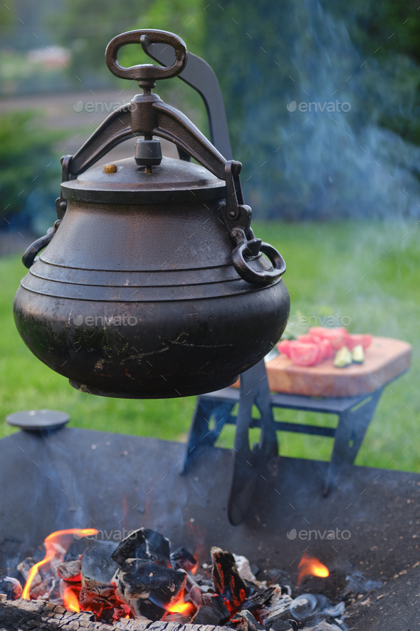 Cast iron pot over the fire Stock Photo by boomeart | PhotoDune