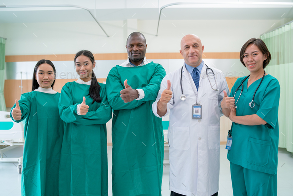 Portrait of doctor and nurse stand with thumbs up action in patient ...