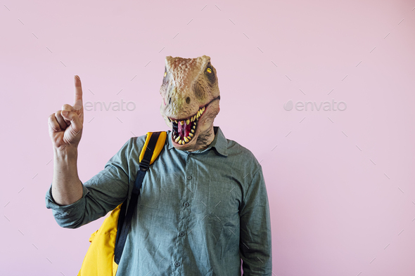 Man in lizard mask on pink background showing two fingers. Stock Photo ...