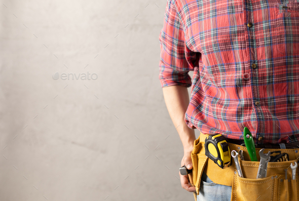 Construction worker man with tool belt house room renovation. Male hand ...