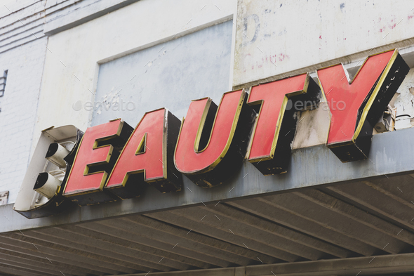 Old BEAUTY sign in front of abandoned department store, red lettering ...