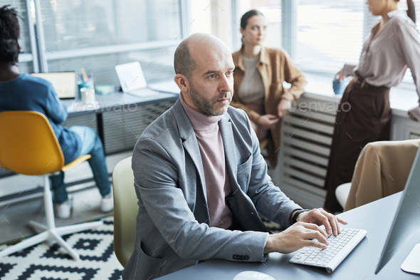Adult Office Worker using Laptop Stock Photo by seventyfourimages ...
