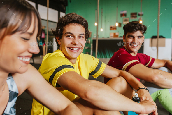 Smiling group of friends laughing together after gym class Stock Photo ...