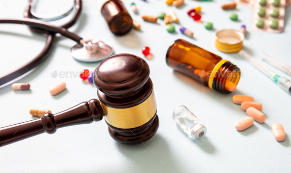 Health and Medicine legal issues. Judge gavel and medication, blue ...
