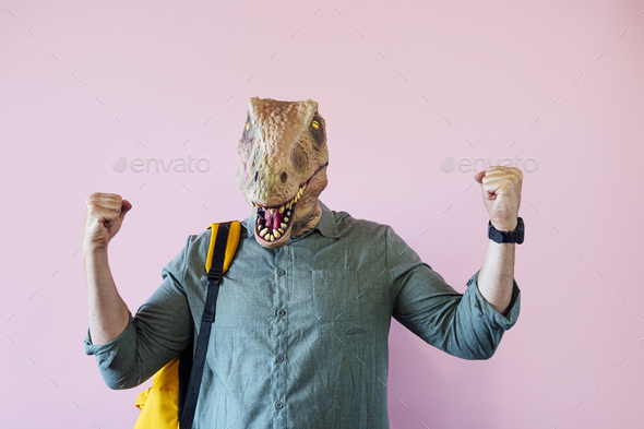 Man with lizard mask on pink background showing his muscles. Stock ...