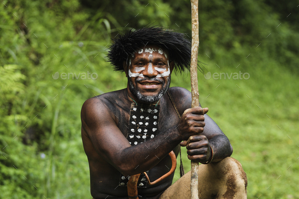 Black man from Papua Indonesia tribe smiling Stock Photo by Garakta-Studio