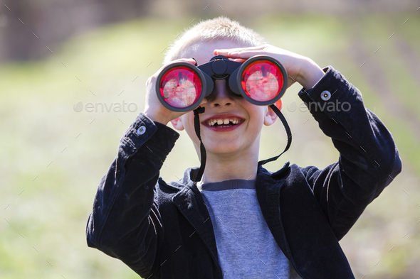 Portrait of little cute handsome cute blond boy watching intently ...