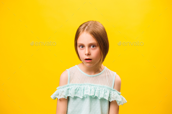 close up of an astonished wow little girl child looking at camera ...