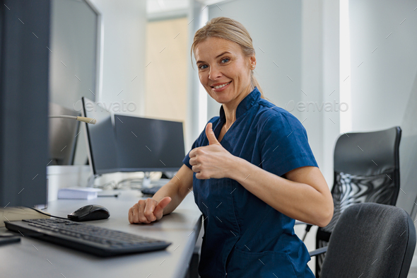Nurse on Duty working on computer at the Reception Desk in modern ...