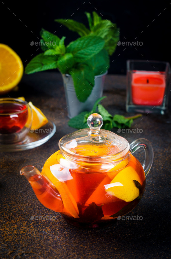 Fruit Tea with orange and lemon Slice, berry, Mint and Honey in teapot ...