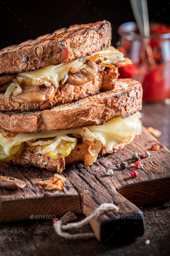 Crunchy and spicy toasts with cheese, mushrooms and onion. Stock Photo ...