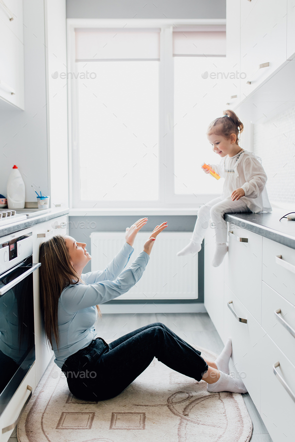 Smiling loving single mother with cute little child daughter having fun ...