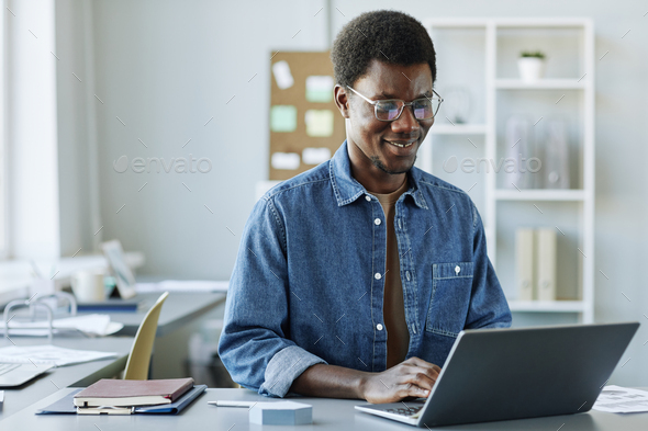 Smiling Black Man with Laptop Stock Photo by seventyfourimages | PhotoDune