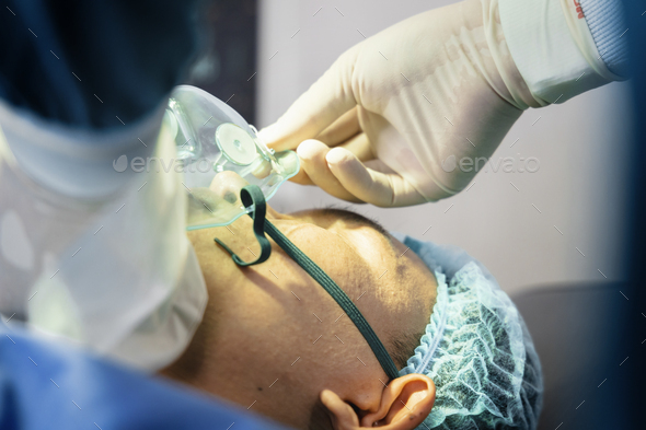 Patient was wearing a ventilator-oxygen mask by assistant surgeon in ...