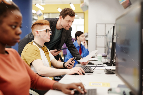 Teacher with Students in Computer Lab Stock Photo by seventyfourimages
