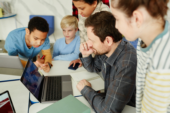 Kids watching Videos with teacher in School Stock Photo by ...