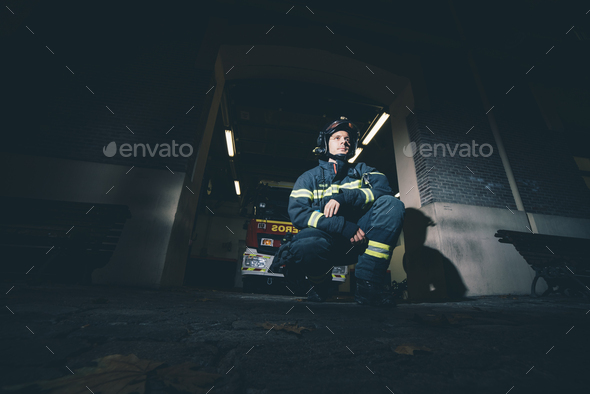 Fireman posing in front of the station. Stock Photo by carrascosaoscar