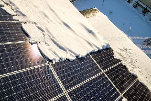 Close up surface of a house roof covered with solar panels in winter ...