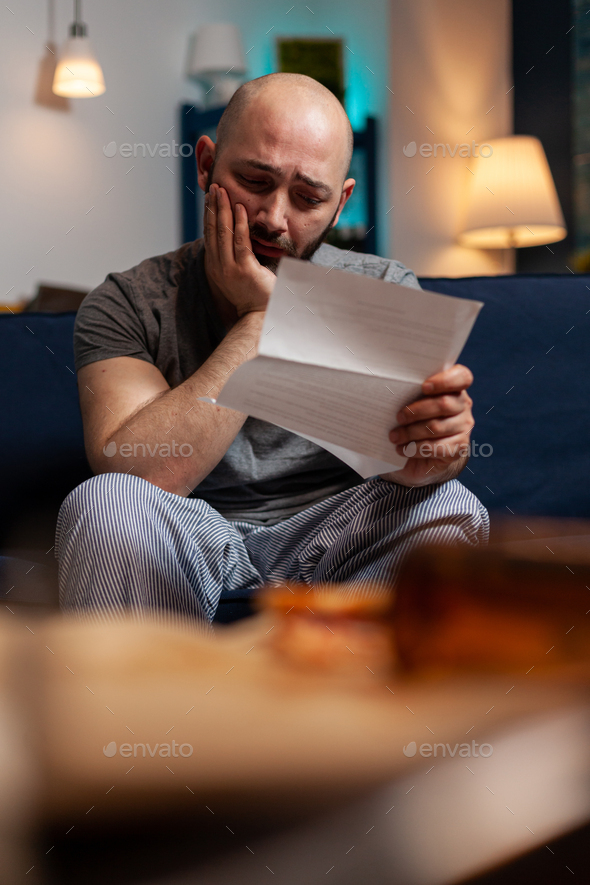 Sad disappointed man feeling worried about eviction notice warning ...